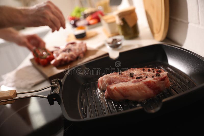 Frying Pan with Fresh Raw Meat on Stove Stock Photo - Image of heat ...