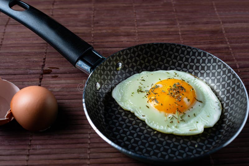Frying Pan with Fried Egg on a Bamboo Table Stock Image - Image of ...