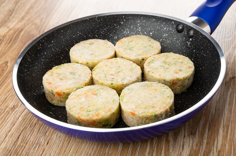Frying Pan with Frozen Vegetable Cutlets on Table Stock Photo - Image ...