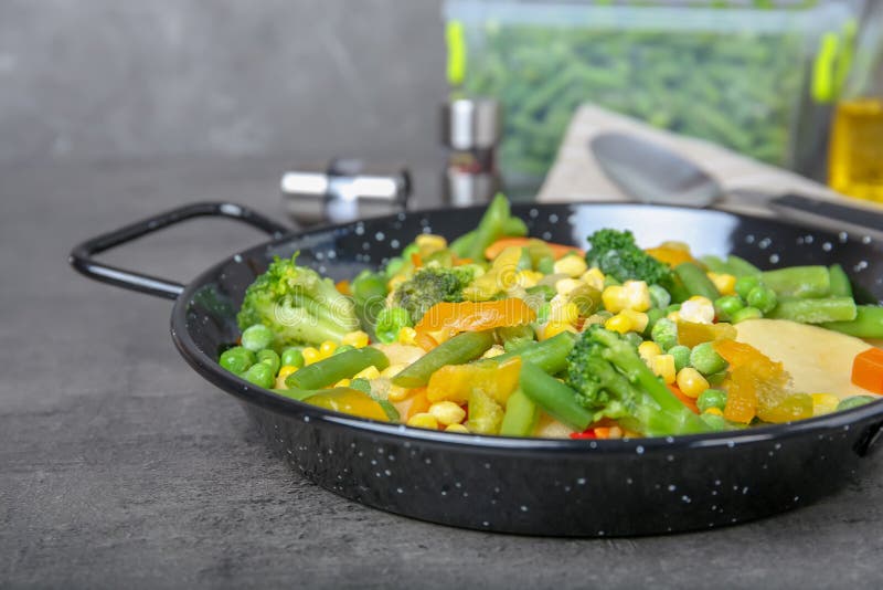 Frying Pan with Frozen Vegetables on Table Stock Photo - Image of ...