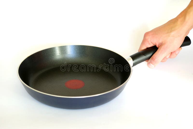 Hand is holding a skillet stock photo. Image of meal - 28682408