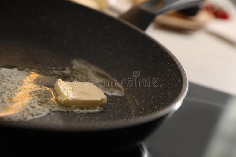 Frying Pan with Melted Butter on Stove Stock Image - Image of melted ...