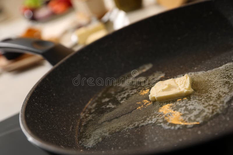 Frying Pan with Melted Butter on Stove, Closeup Stock Photo - Image of ...