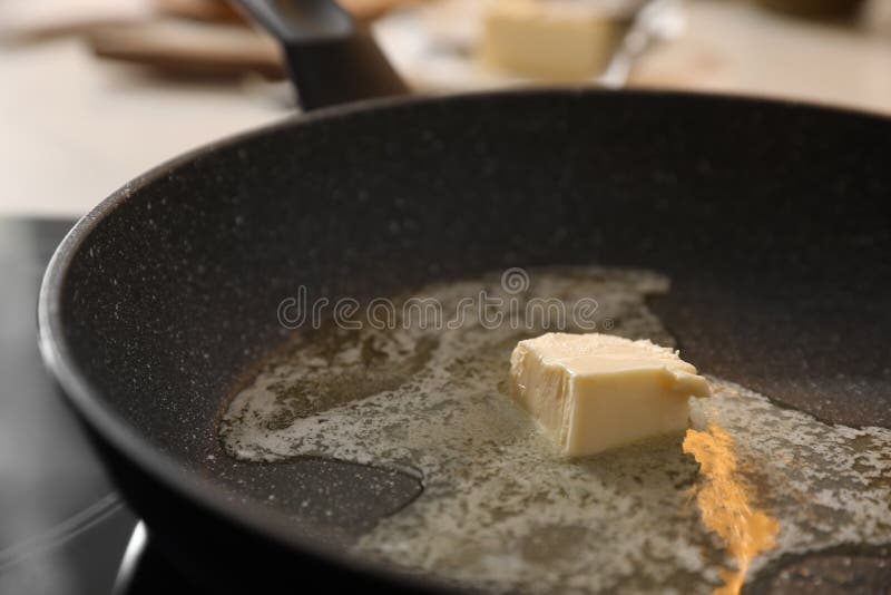 Frying Pan with Melted Butter on Stove, Closeup Stock Image - Image of ...