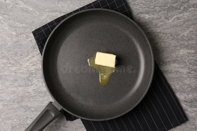 Frying Pan with Melting Butter on Grey Table Stock Photo - Image of ...