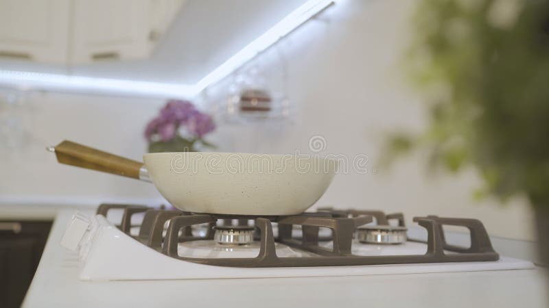 Frying Pan in Modern Kitchen with Induction Stove. White Frying Pan in ...
