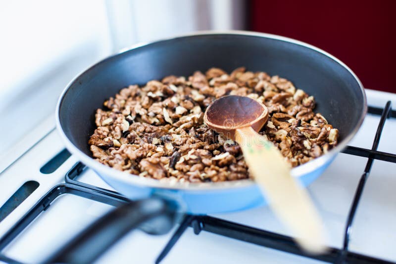 A frying pan with nuts stock image. Image of diet, focus - 26643773