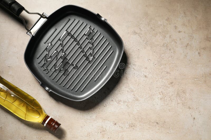 Frying Pan with Oil and Bottle on Gray Textured Table, Flat Lay. Space ...