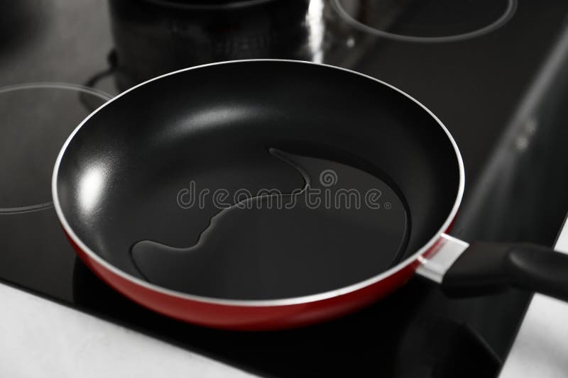 Frying Pan with Oil on Cooktop in Kitchen, Closeup Stock Photo - Image ...