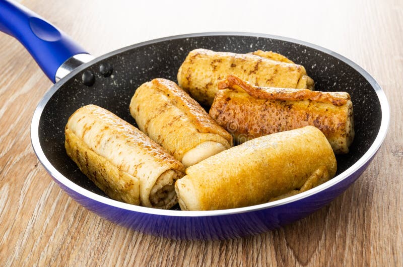 Frying Pan with Pancake Roll on Table Stock Image - Image of fried ...