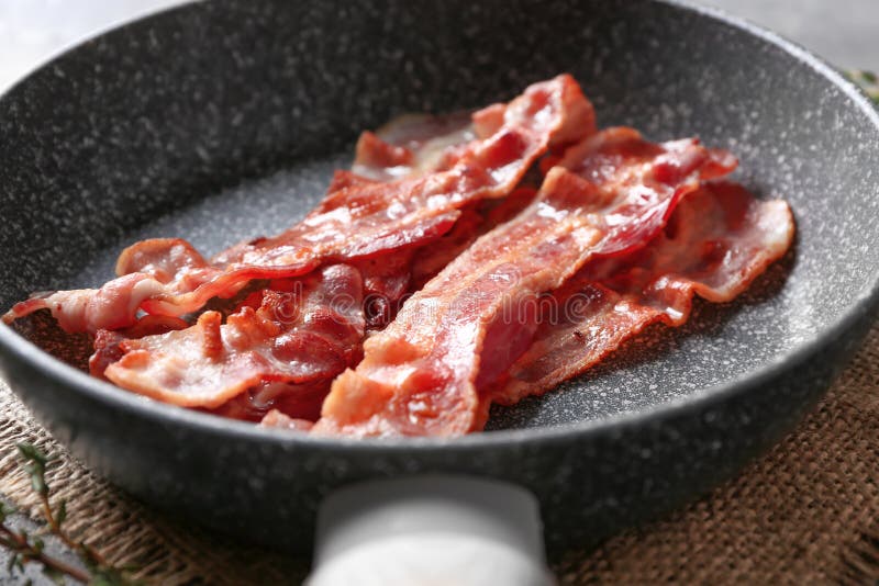 Frying Pan with Tasty Bacon on Table, Closeup Stock Photo - Image of ...