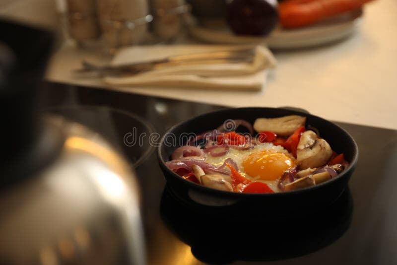Frying Pan with Tasty Egg and Vegetables on Stove, Space for Text Stock ...