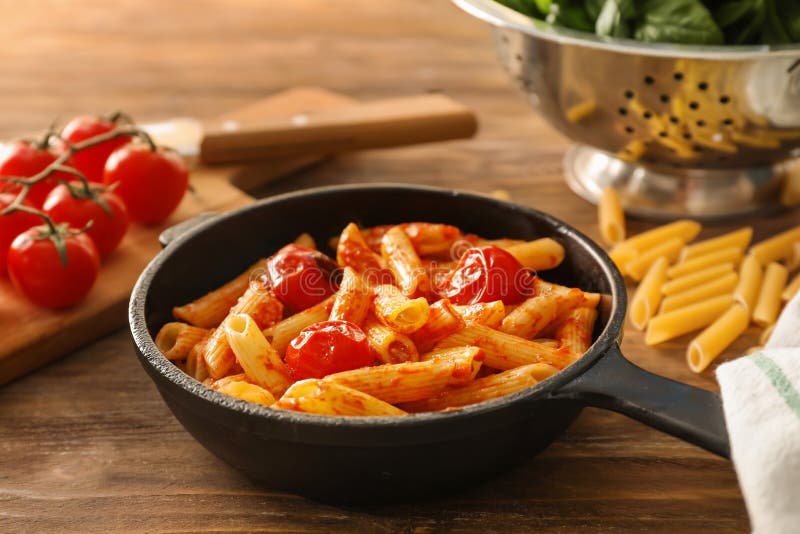 Frying Pan with Tasty Penne Pasta on Wooden Table Stock Photo - Image ...