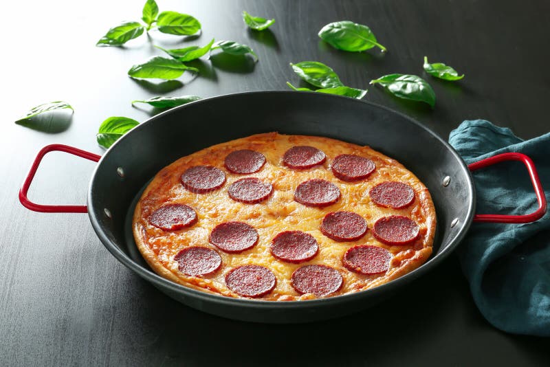 Frying Pan with Tasty Pizza on Dark Table Stock Photo - Image of table ...