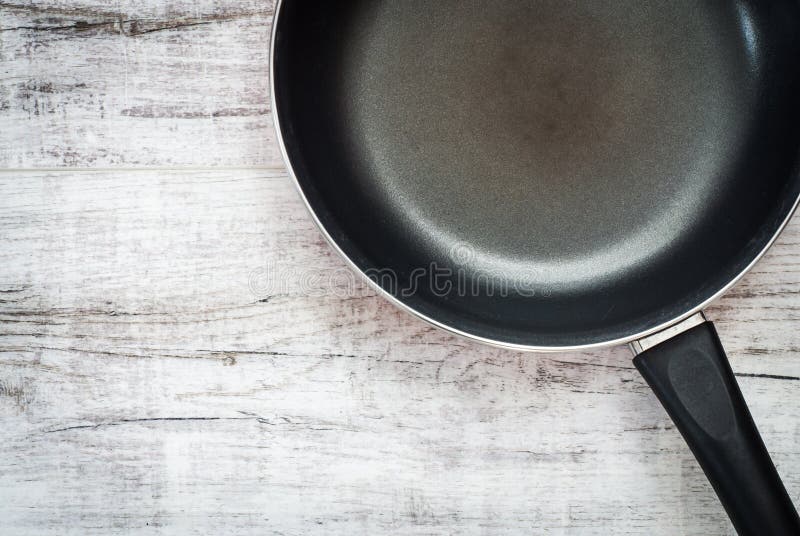 Frying Pan on Wooden Table. Stock Photo - Image of black, cooking: 85257416