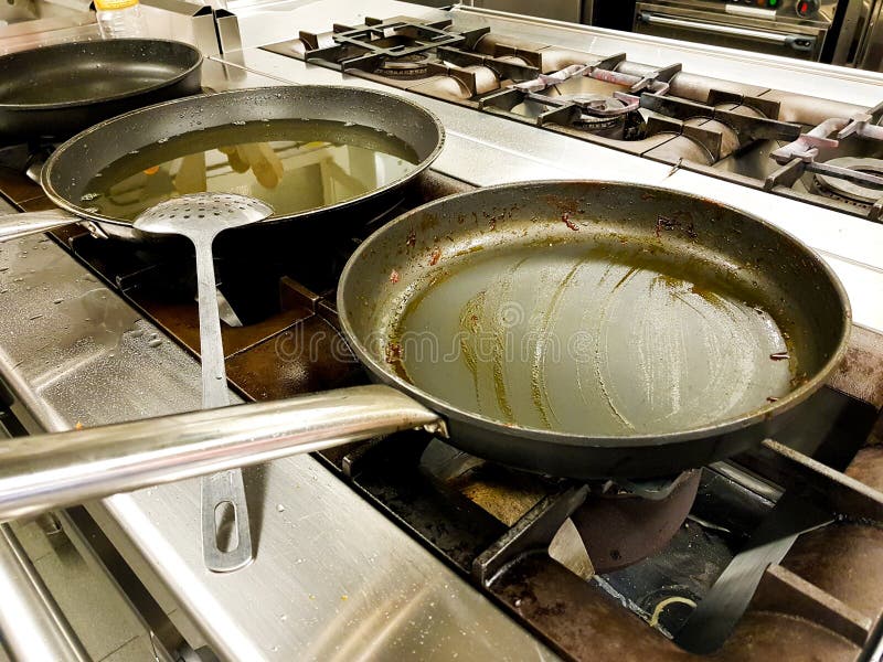 Frying Pans with Oil and Cooking in the Kitchen of a Restaurant Stock ...