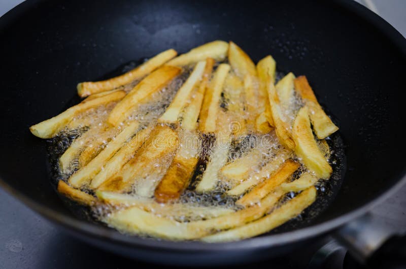 Frying potatoes in a pan stock image. Image of salter - 49159775