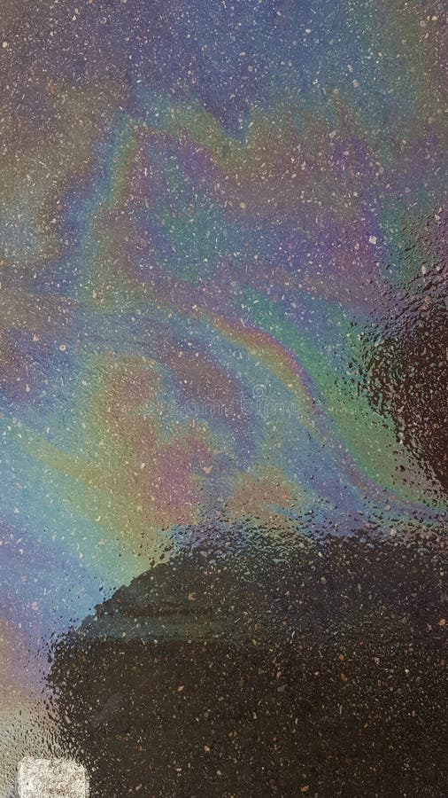 Fuel spot on road stock photo. Image of rainbow, road - 67639174