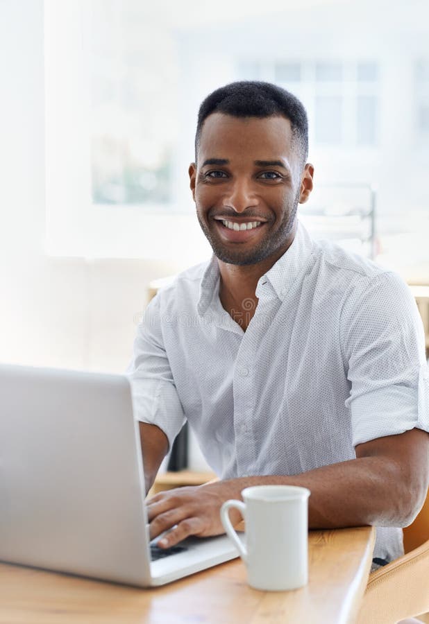 Fulfilled by His Work. a Handsome Young Businessman Working in an ...