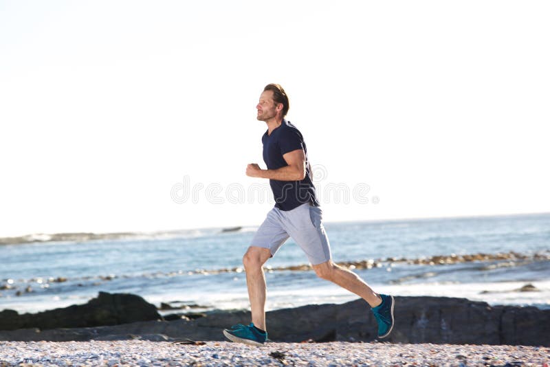 Full Body Portrait of Active Man Running by Beach Stock Photo - Image ...