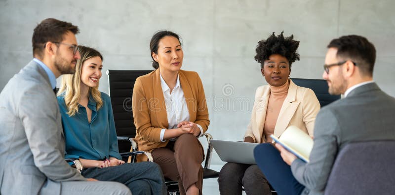 Group of Young Business People Working As a Team and Communicating in ...