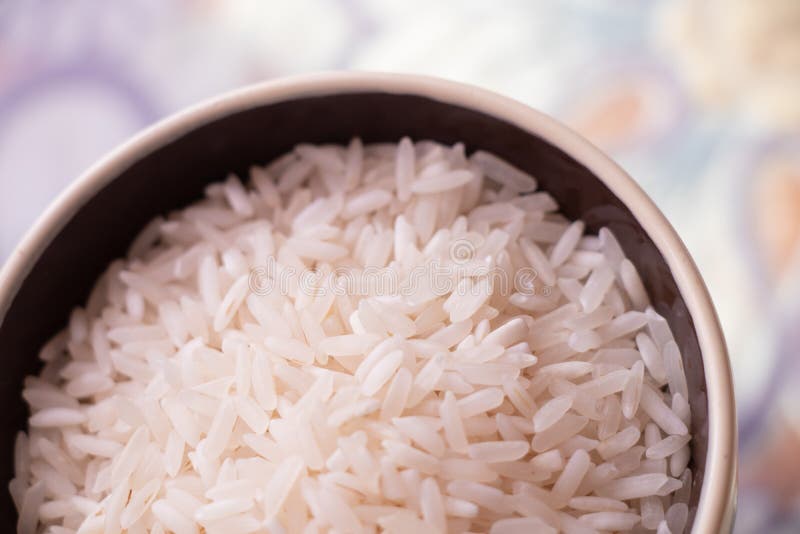 A Full Cup of Raw Long Grain Rice on a Table in the Kitchen Stock Photo ...