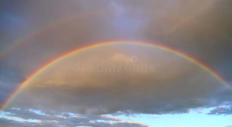 Full Double Rainbow in the Sky Against the Background of Clouds Stock ...
