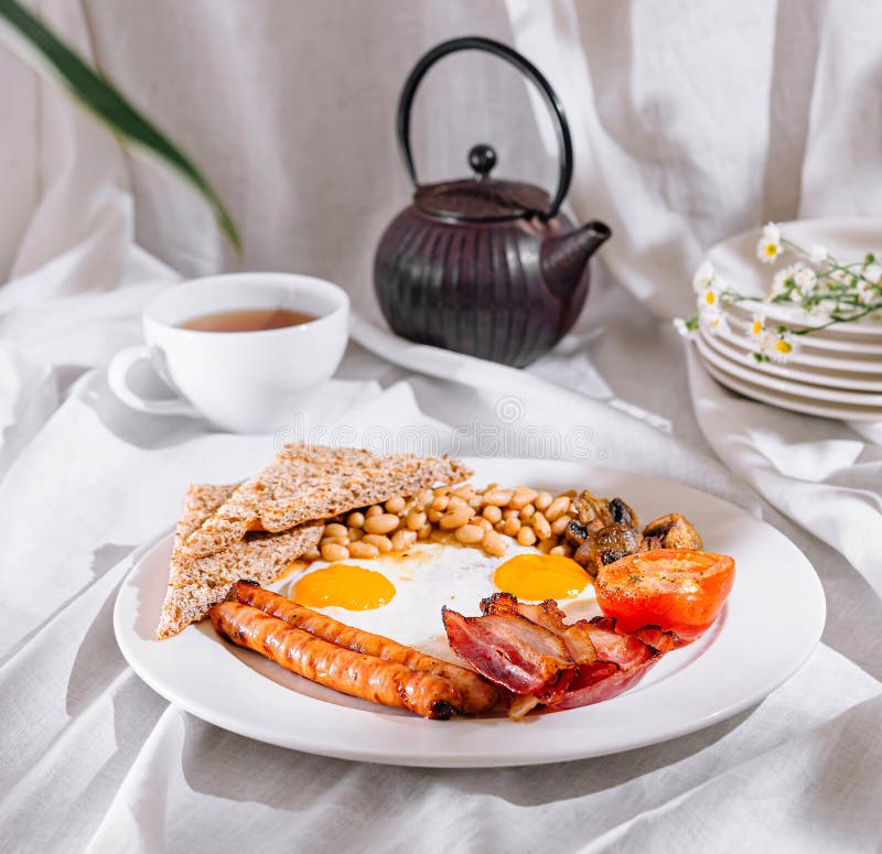 Full English Breakfast with Crispy Bacon and Sunny Side Up Eggs Being ...