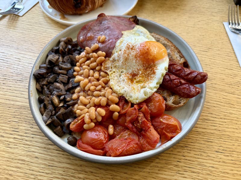 Full English Breakfast with Crispy Bacon and Sunny Side Up Eggs is ...