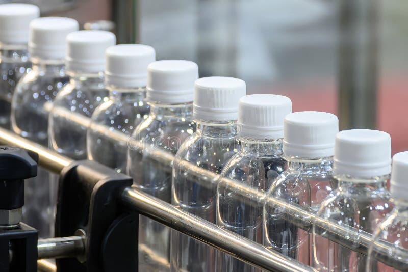 The Full Filled Drinking Water Bottles on the Conveyor Belt in the ...
