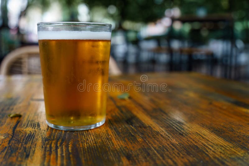 Full Glass of Beer on a Wooden Restaurant Table Stock Image - Image of ...
