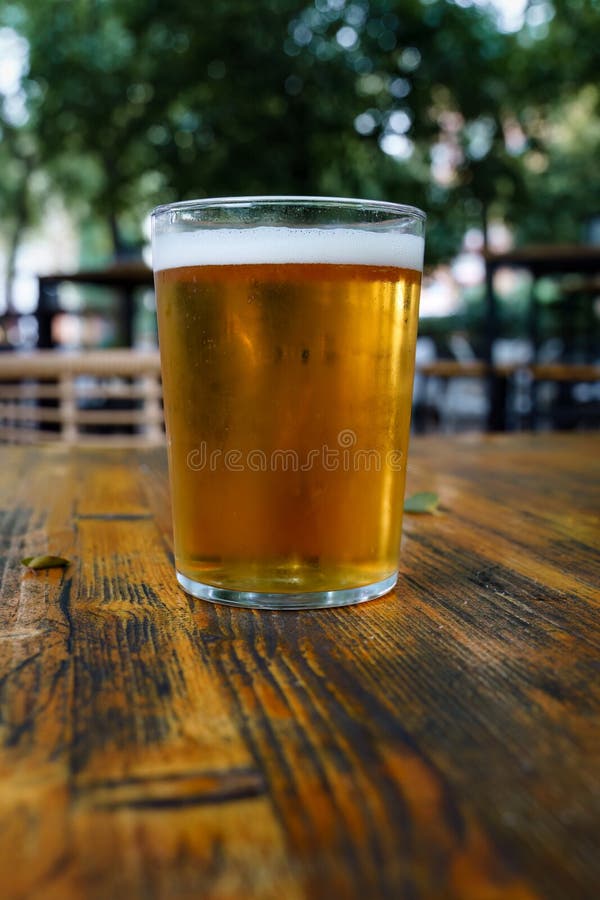 Full Glass of Beer on a Wooden Restaurant Table Stock Image - Image of ...