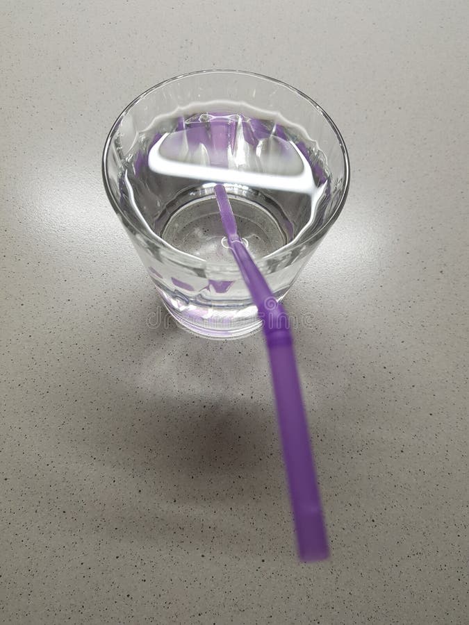 Full Glass of Water with Purple Drinking Tube on a Marble Table Stock ...
