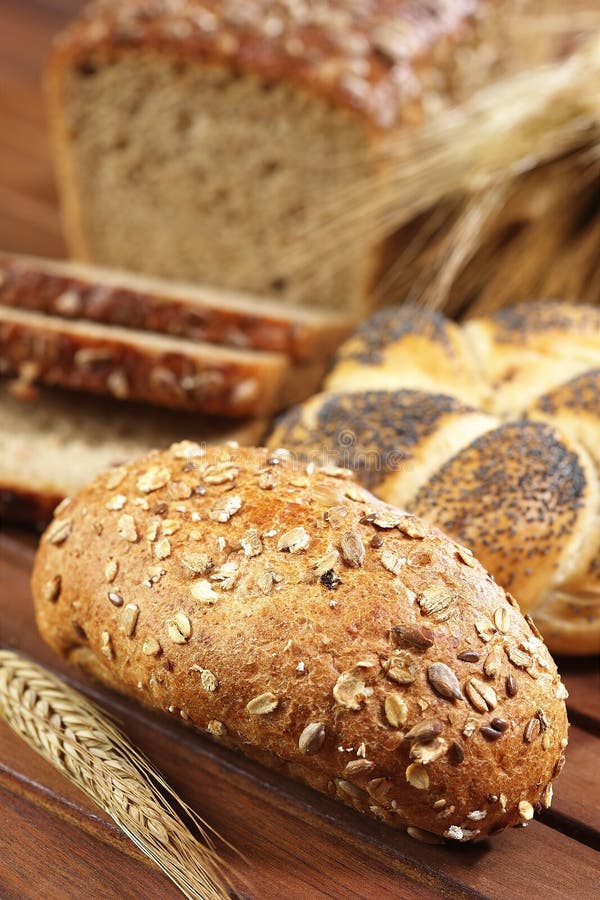 Full Grain Bread Roll on Wooden Table with Ear of Rye Stock Photo ...