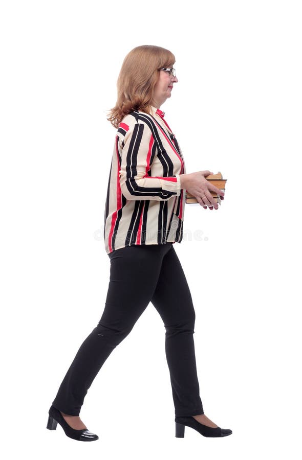In Full Growth. Confident Woman with a Stack of Books Striding Forward ...
