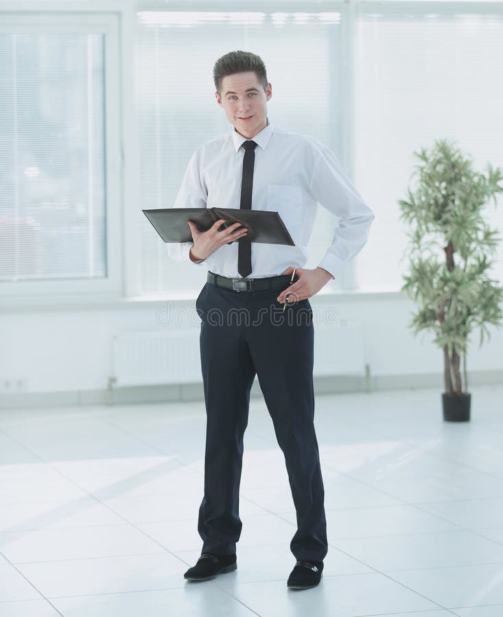 Serious Employee with Documents Standing in the Office Stock Photo ...