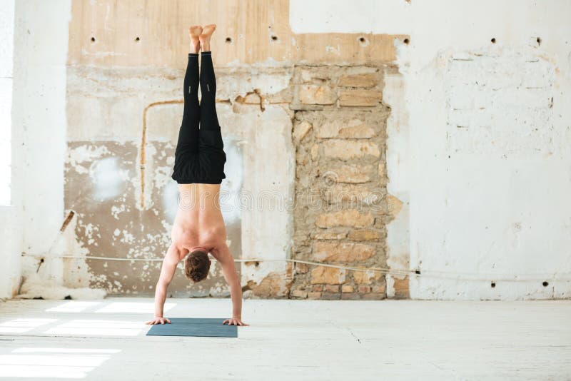 Full Length Back View of a Man Practising Yoga Poses Stock Photo ...