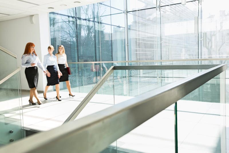 Full-length of Businesswomen Walking at Office Hallway Stock Image ...