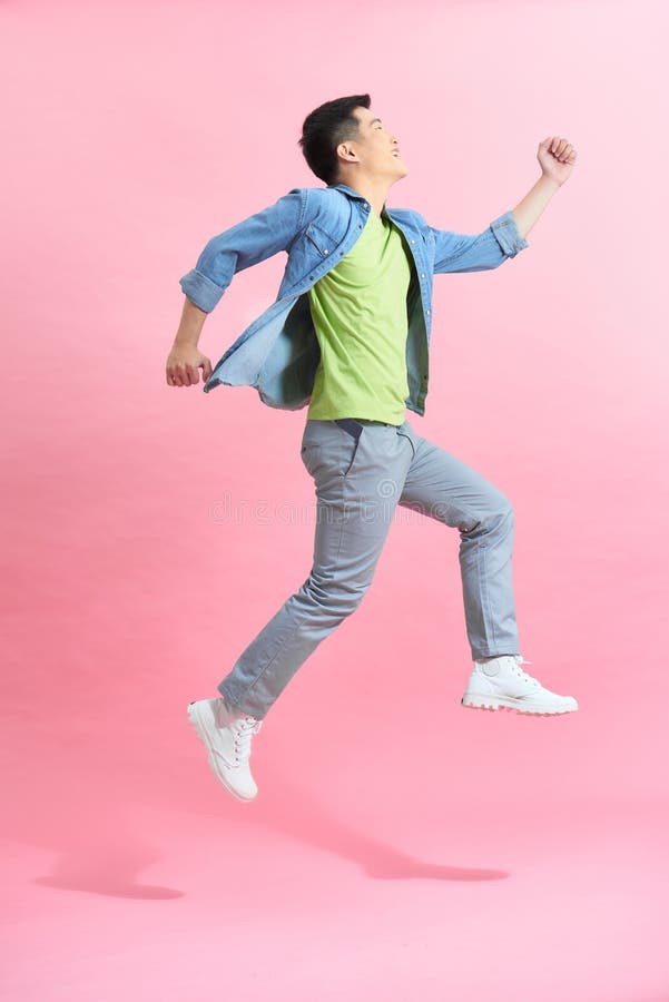 Excited Boy Levitating Over Shocked Brother Sitting on Bedding Stock ...