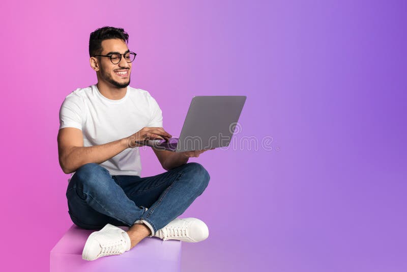 Full Length of Millennial Arab Man in Glasses Using Laptop for Work or ...