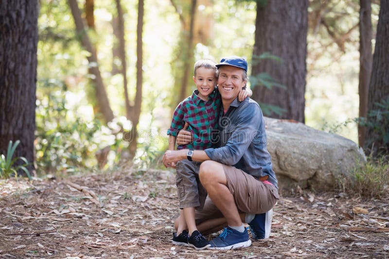 Full Length Portrait of Smiling Father and Son in Forest Stock Image ...