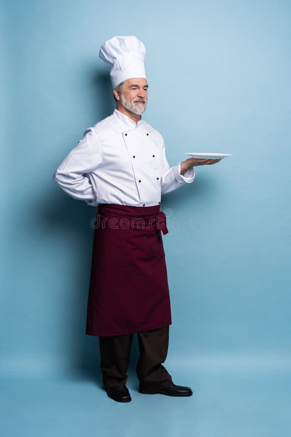 Full Length of a Professional Chef Holding an Empty Plate on Light Blue ...