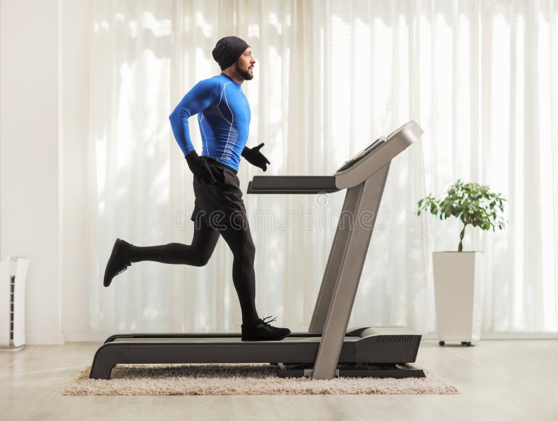Profile Shot of a Man Running on a Treadmill Indoors Stock Image ...