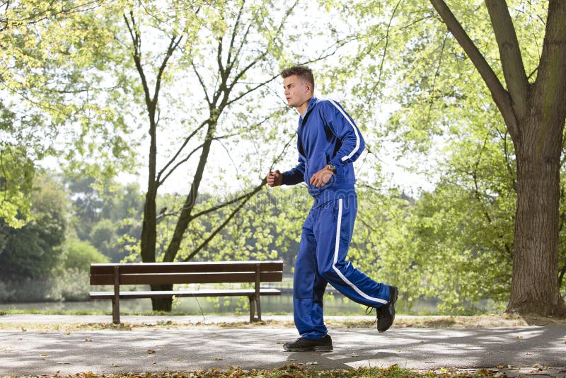 Full Length Side View of Man Jogging on Path in Park Stock Image ...