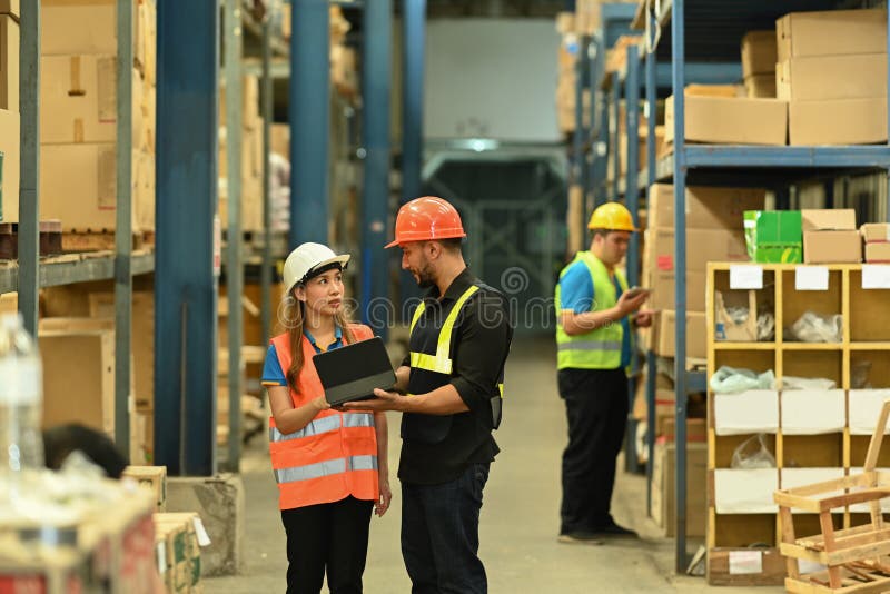 Full Length of Two Warehouse Workers are Standing between Retail ...