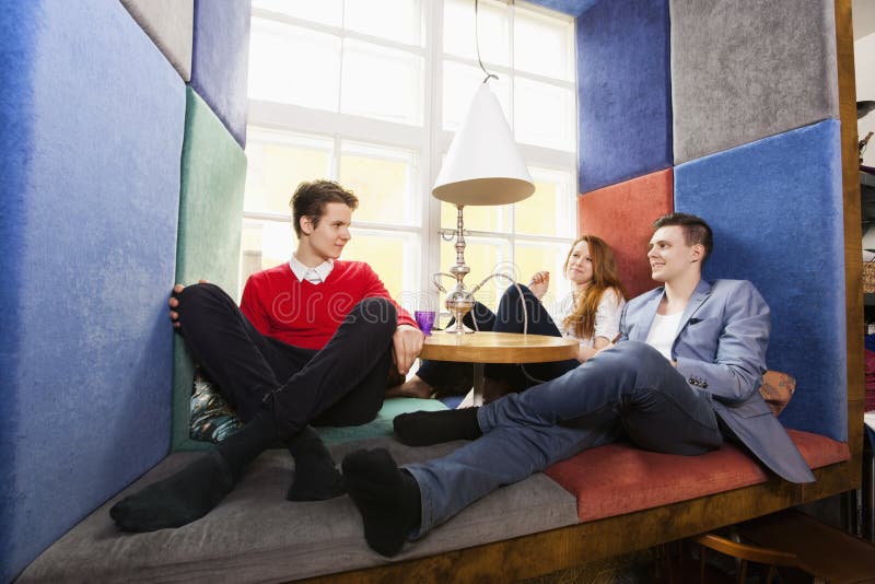 Full Length of Young Friends Having Hookah at Restaurant Stock Image ...