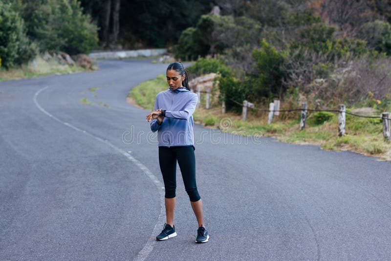 Full Length of Young Slim Female Checking Pulse during Exercise Stock ...