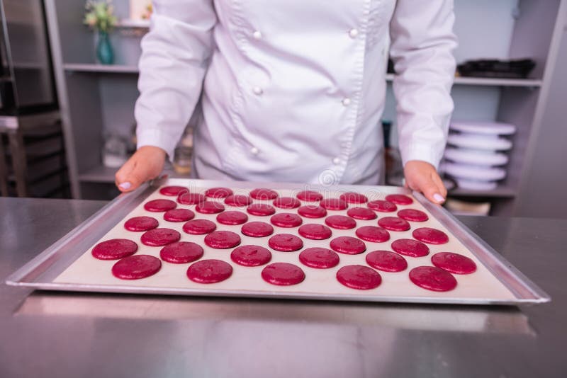 Chef Standing Near the Table with Baking Pan Full of Macaroons Stock ...
