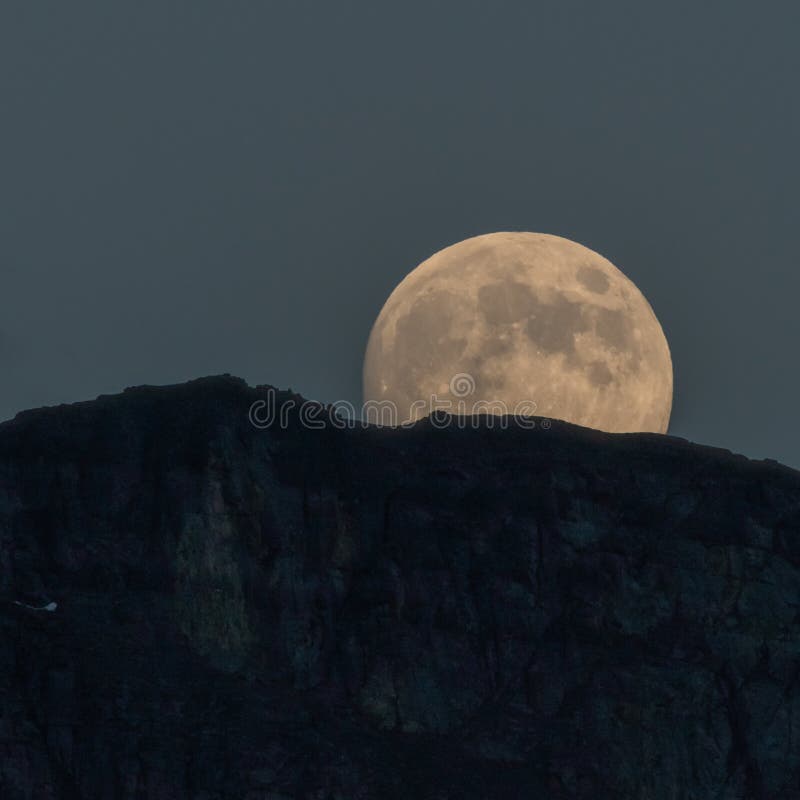 Full Moon Emerges Behind Mountain Stock Photo - Image of mountain, dark ...