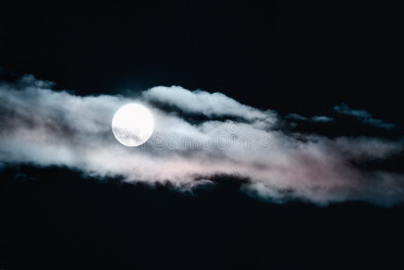 Full Moon in the Night Sky Hidden Behind Clouds Tinted with Sunset ...